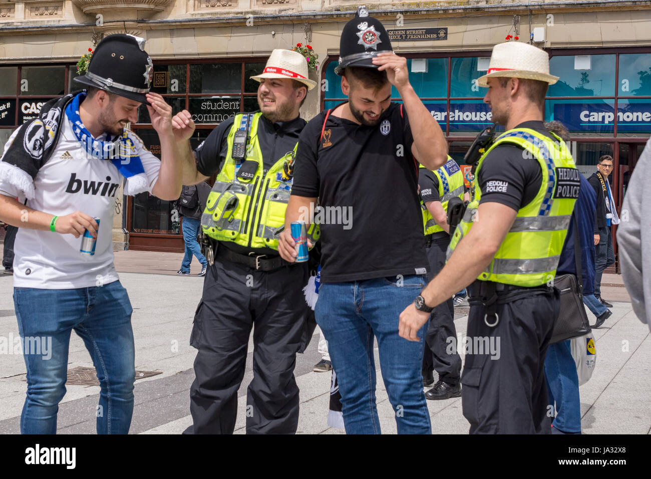 Police and fans swapping hats, Cardiff centre. Champions League Final ...