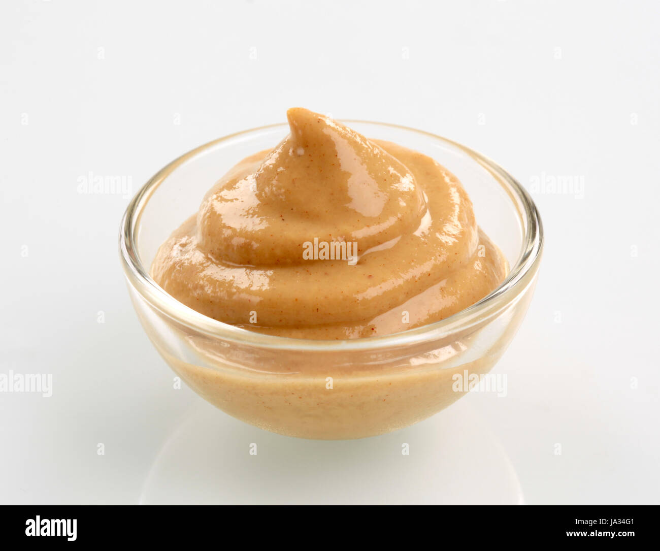 Swirl of spicy mustard in a small glass bowl Stock Photo - Alamy