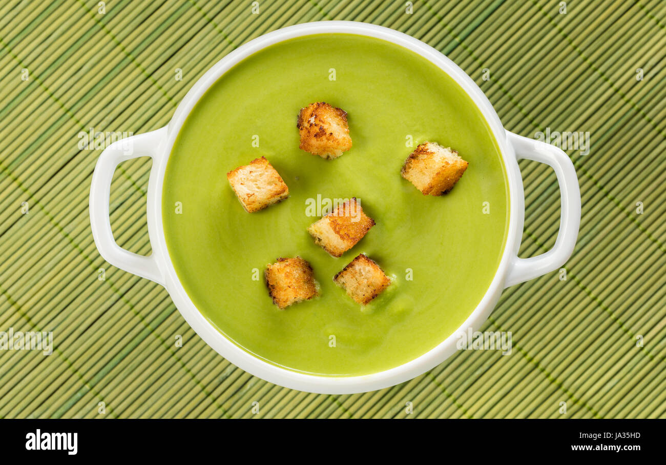 cream soup puree of green peas with croutons Stock Photo - Alamy