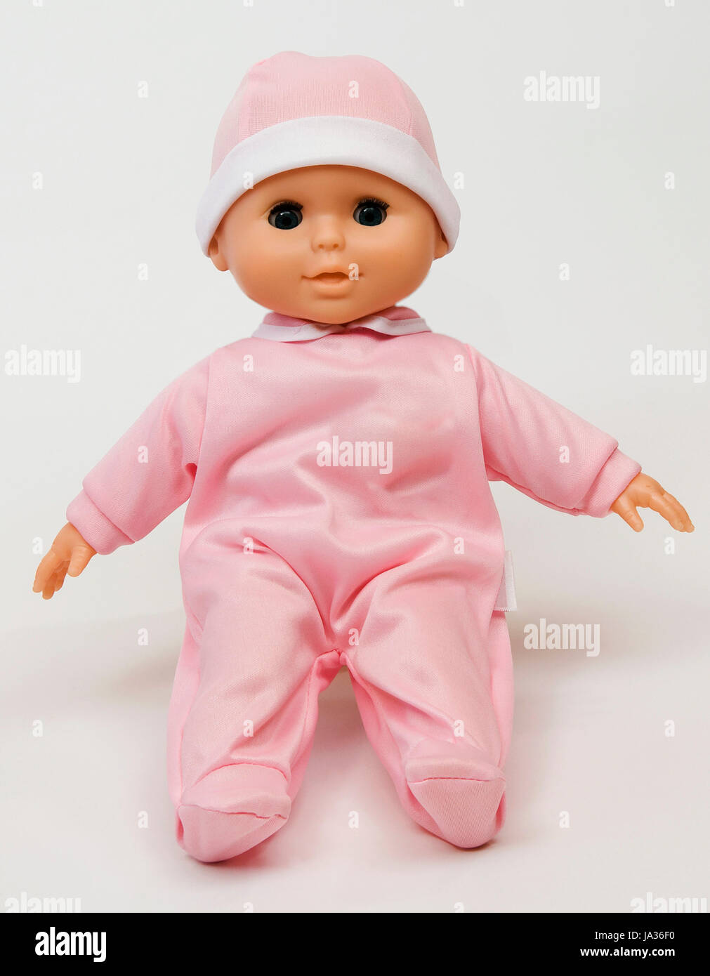 Cute baby doll dressed in pink Stock Photo - Alamy