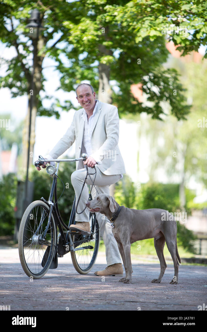 man with dog and bike Stock Photo - Alamy