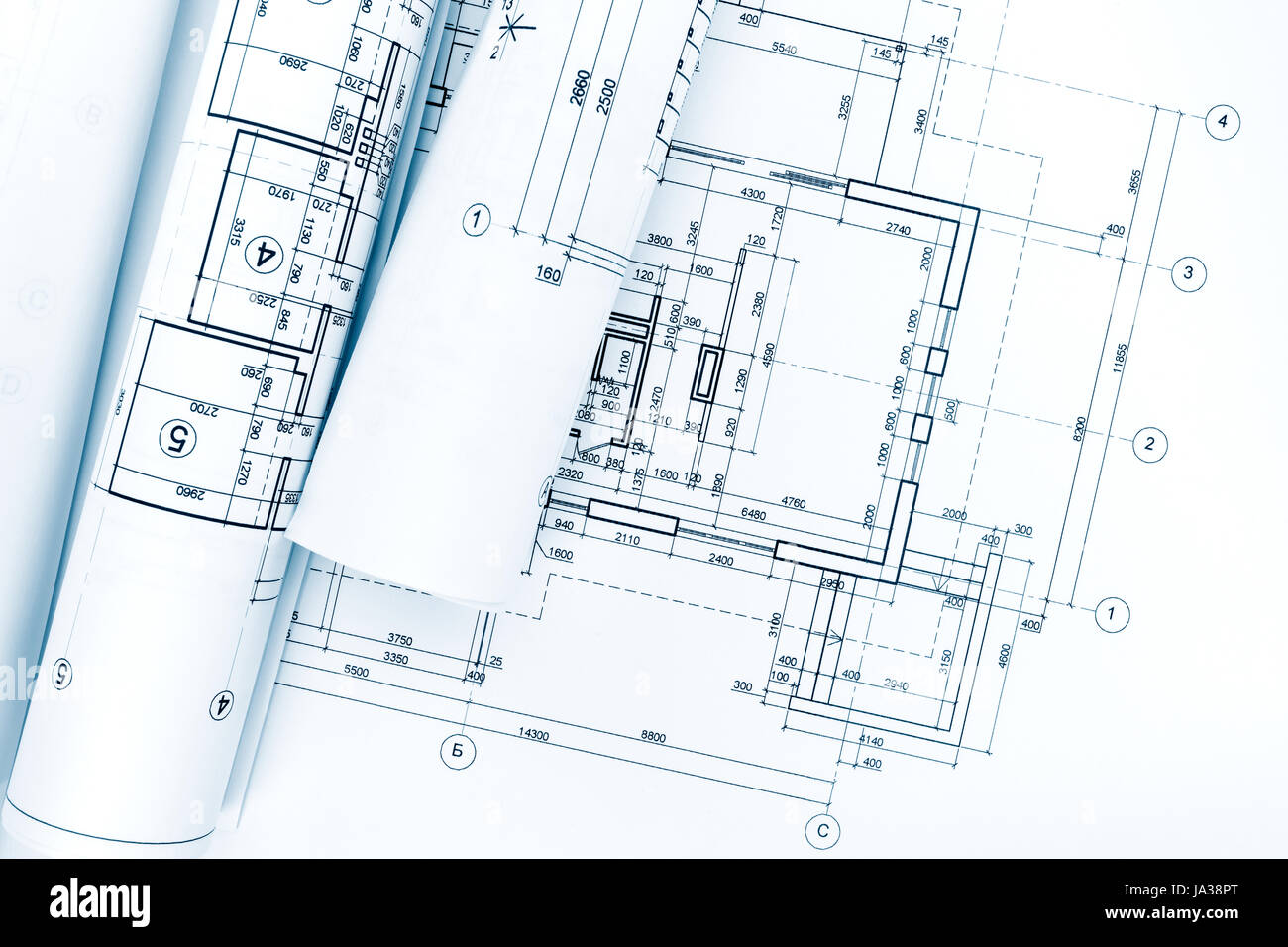 rolls of architectural blueprints and technical drawings on architect ...