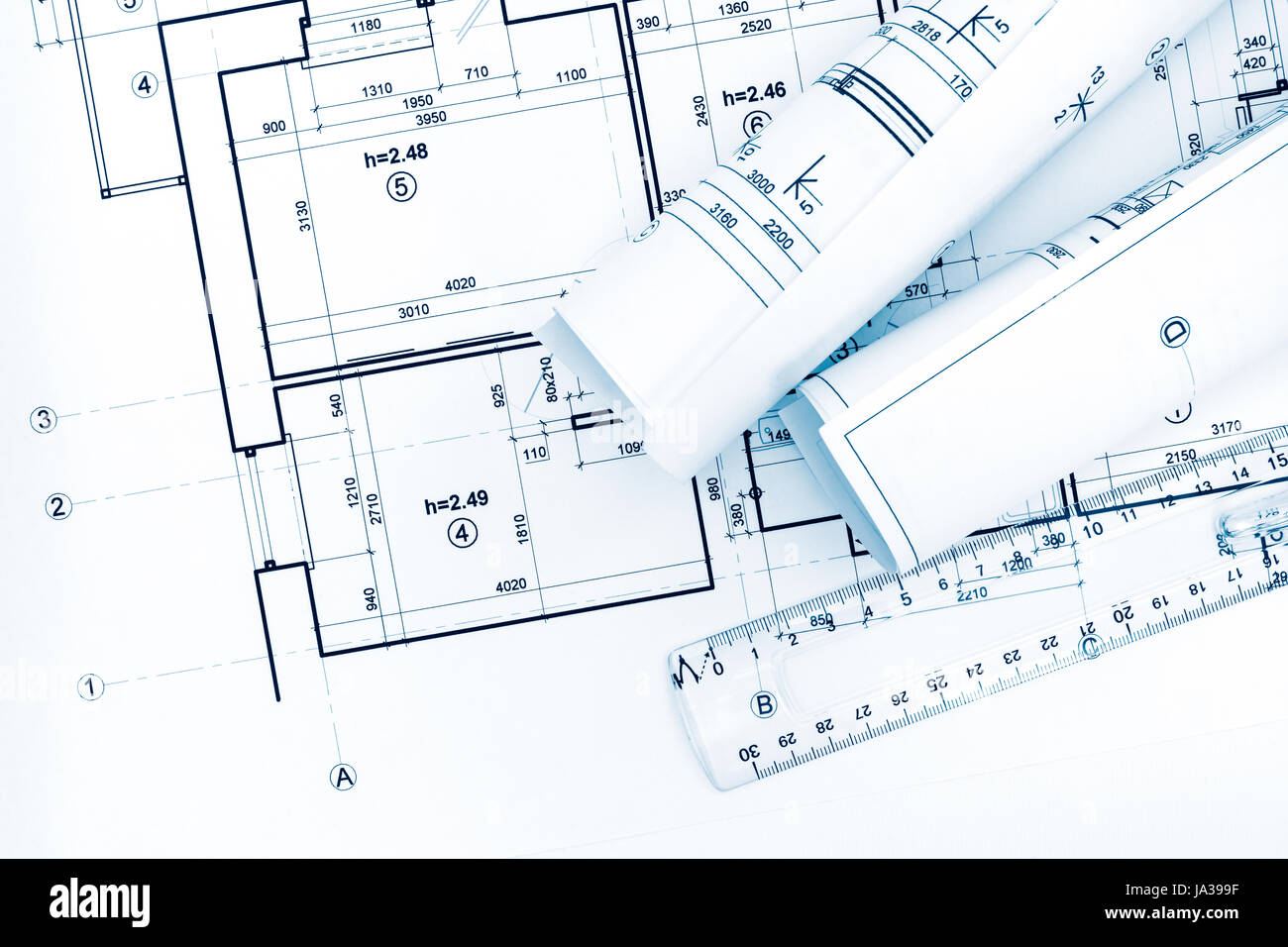 rolls of drawing paper with blueprints and architectural plans top view ...