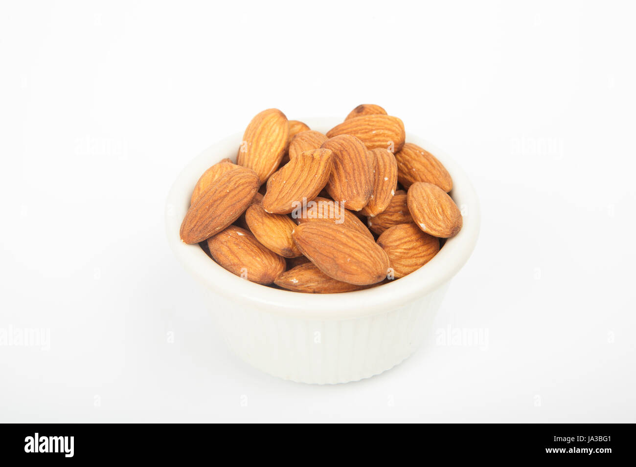 Many almonds isolated on white background Stock Photo - Alamy