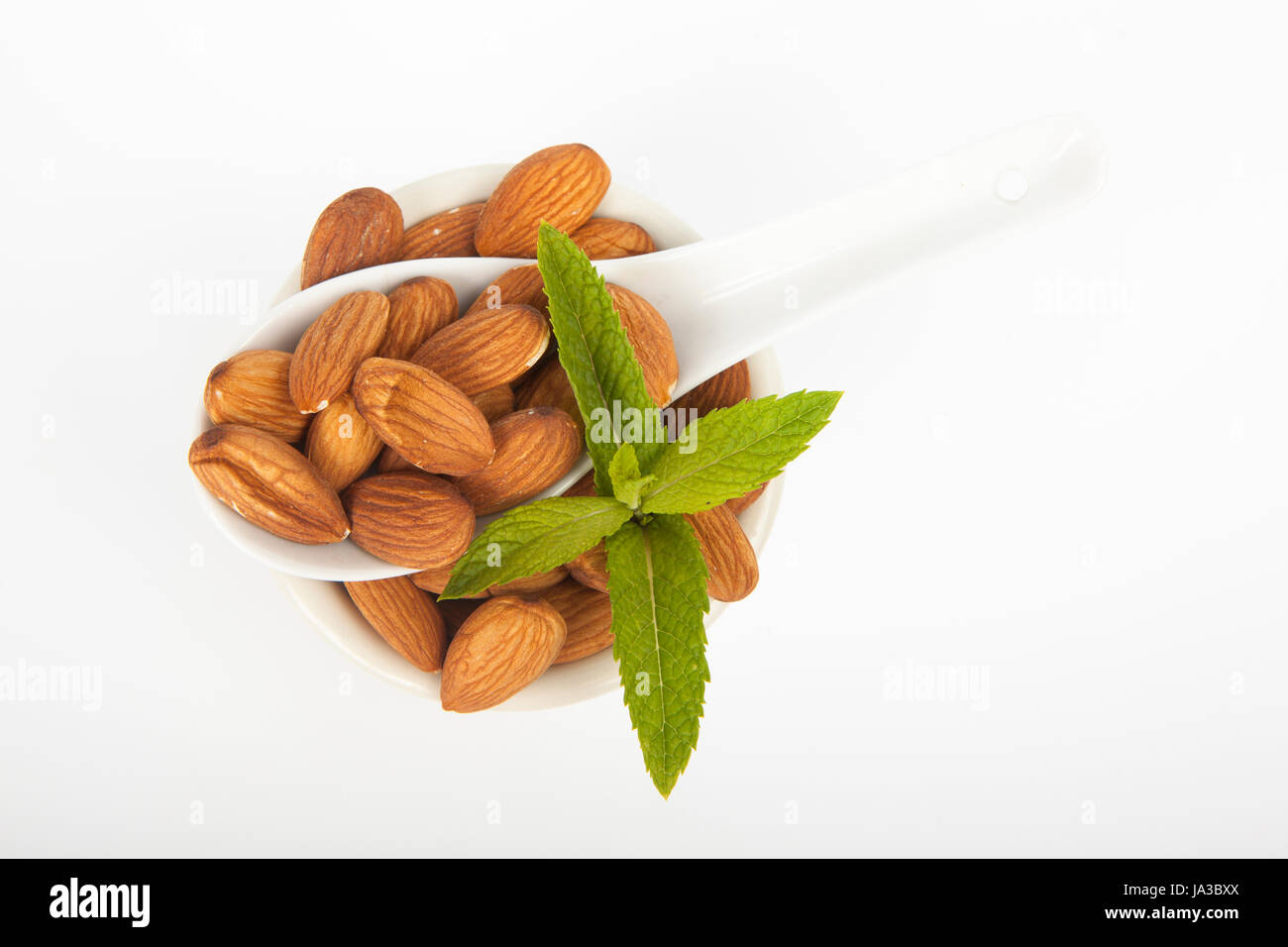 Many almonds isolated on white background Stock Photo - Alamy