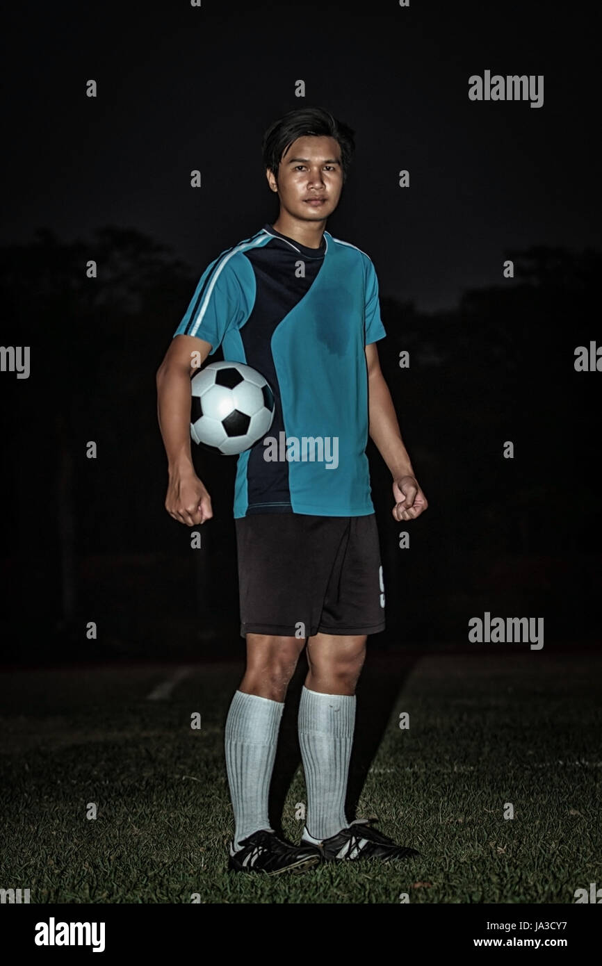 blurry and soft focus of football player holding ball on football ...
