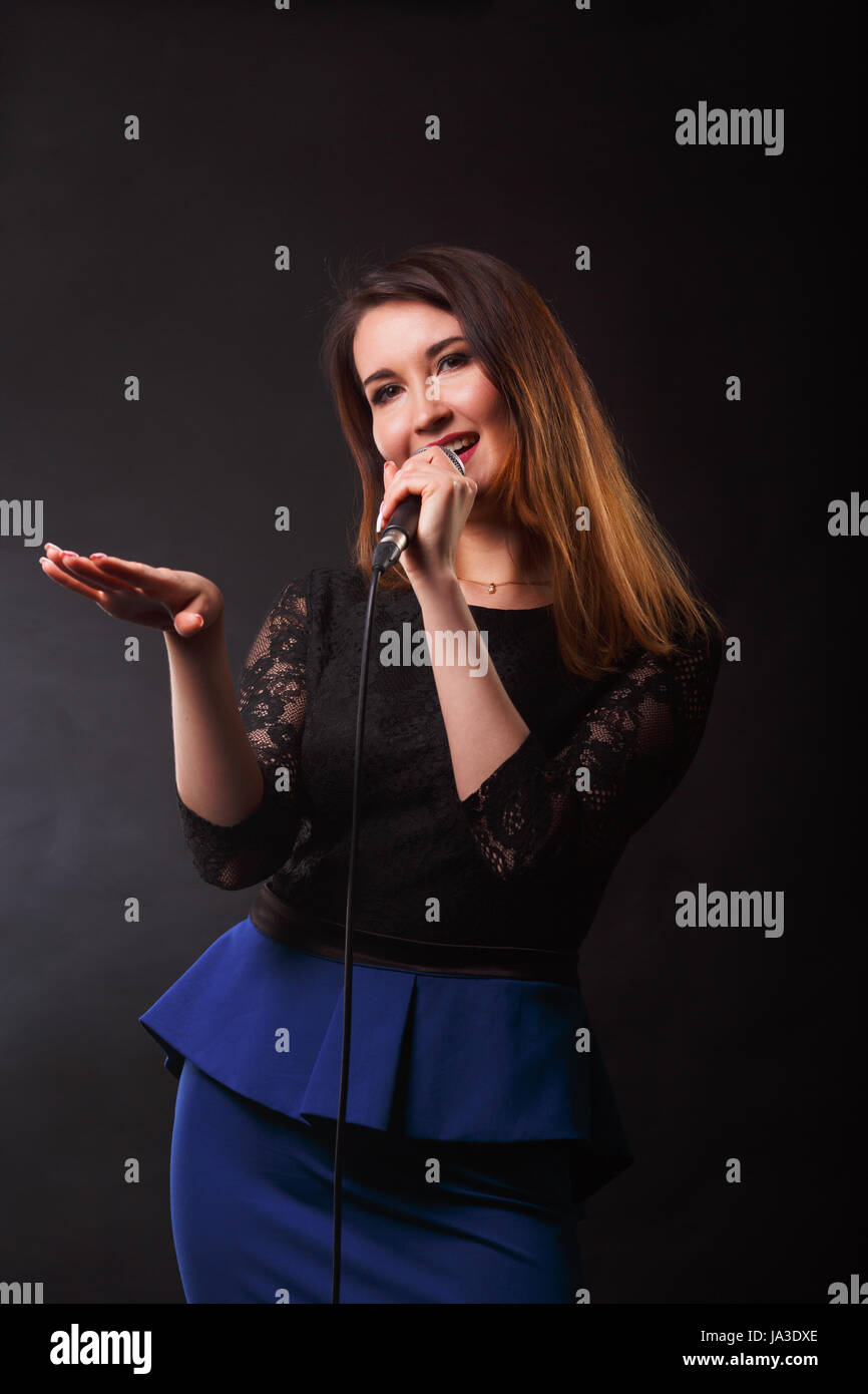 Long haired woman with microphone Stock Photo - Alamy