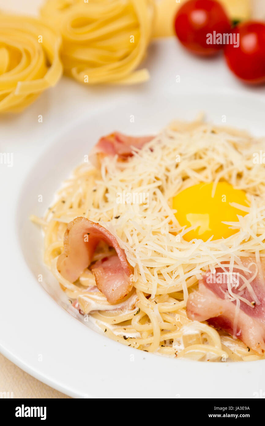 hot pasta with garnish on white plate Stock Photo - Alamy