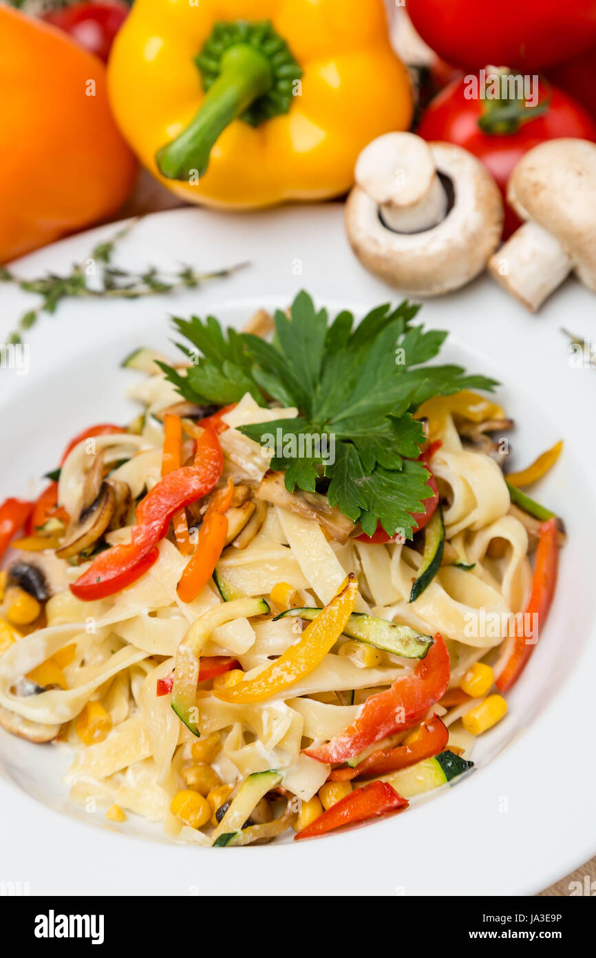 hot pasta with garnish on white plate Stock Photo - Alamy