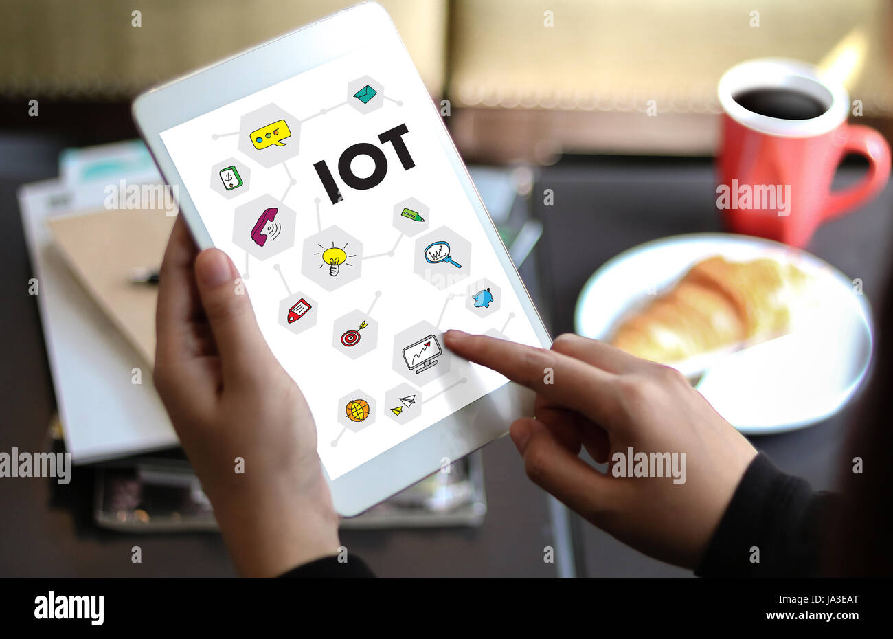 IOT business man hand working and internet of things (IoT) word diagram ...