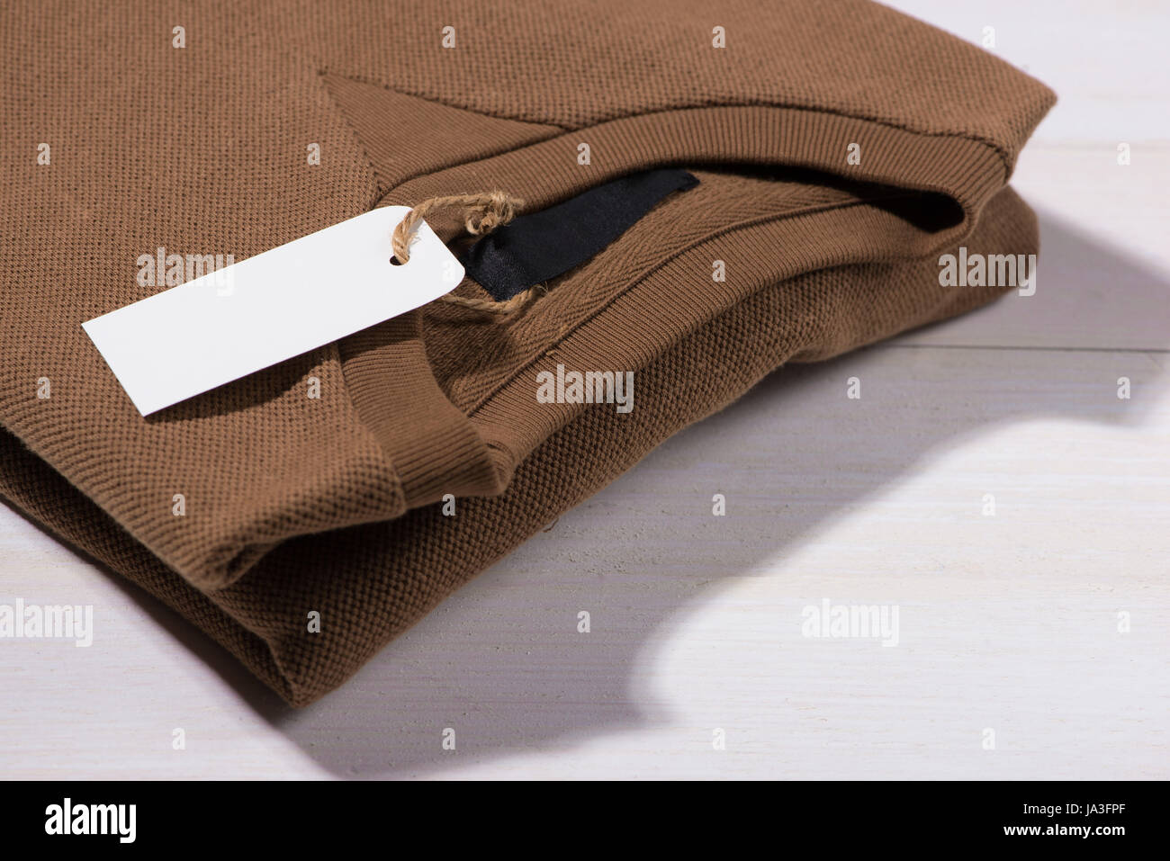 Shirt price tag. Rectangular tag is attached to a sweater Stock Photo ...