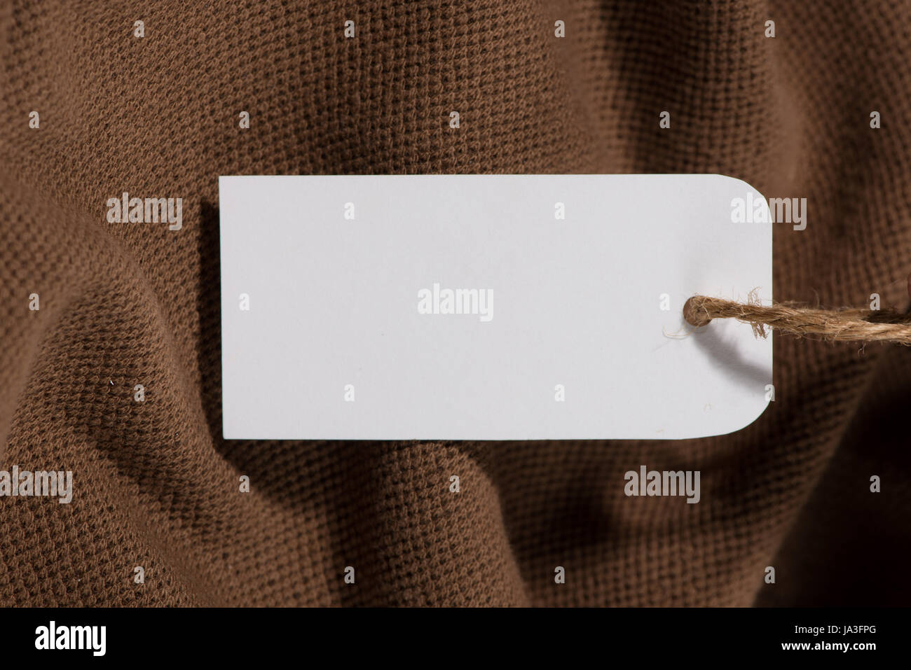 Shirt price tag. Rectangular tag is attached to a sweater Stock Photo ...