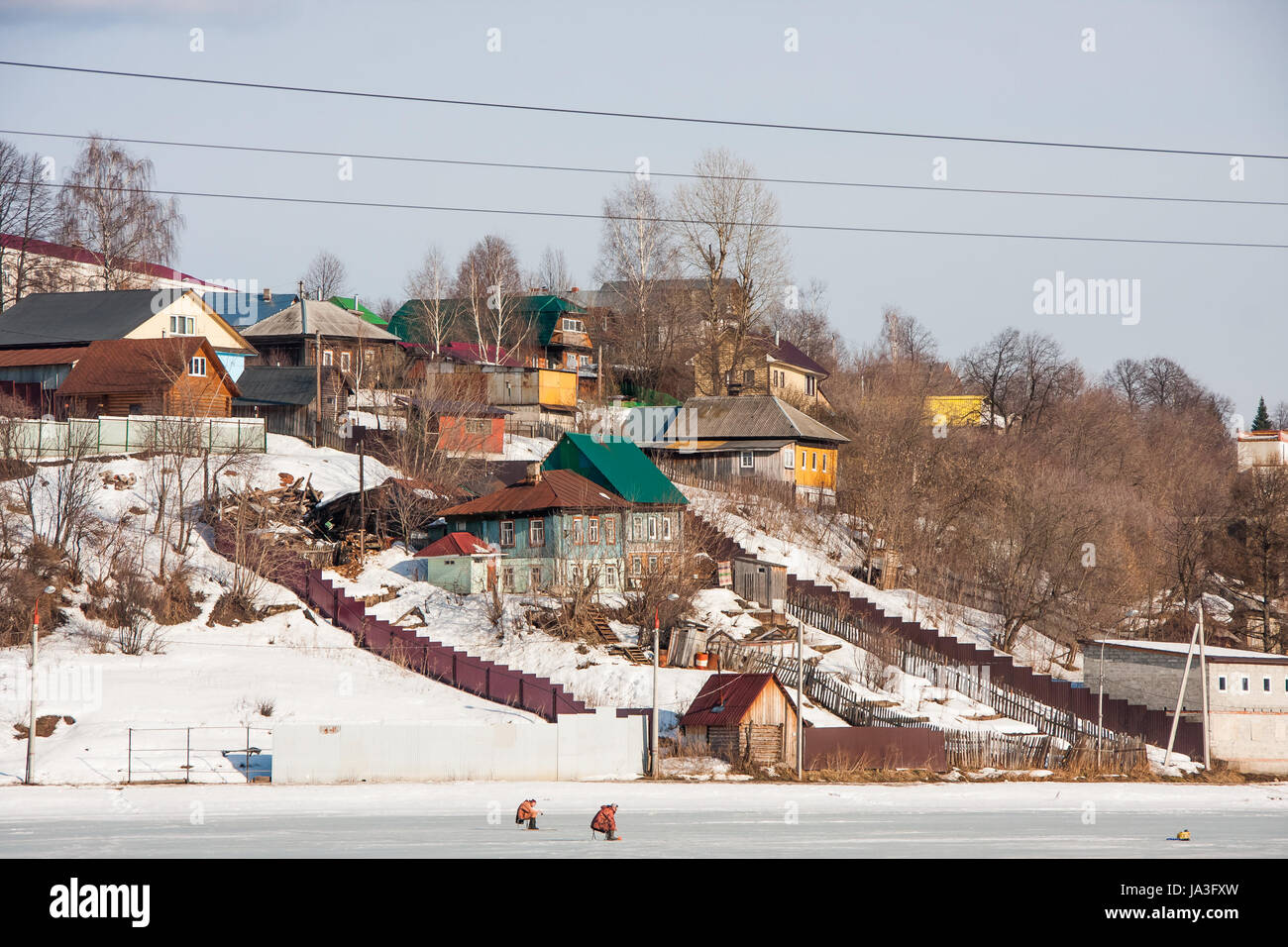 Rural spring landscape with residential houses on the banks of the pond ...