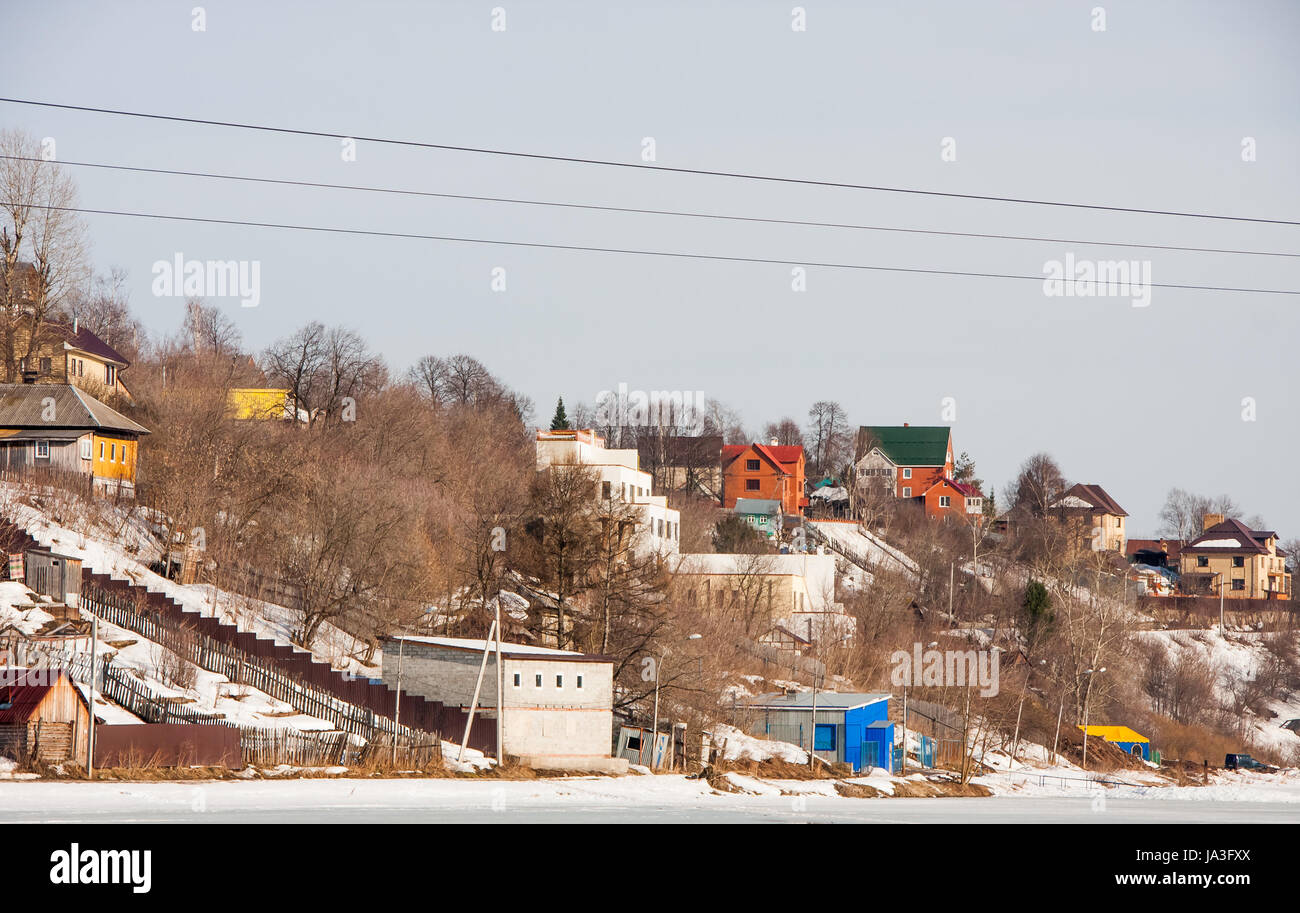 Rural spring landscape with residential houses on the banks of the pond ...