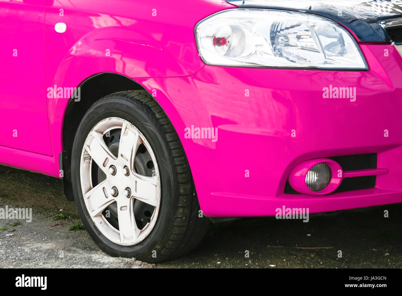 Wing, wheel and car headlight bright color, close-up Stock Photo - Alamy