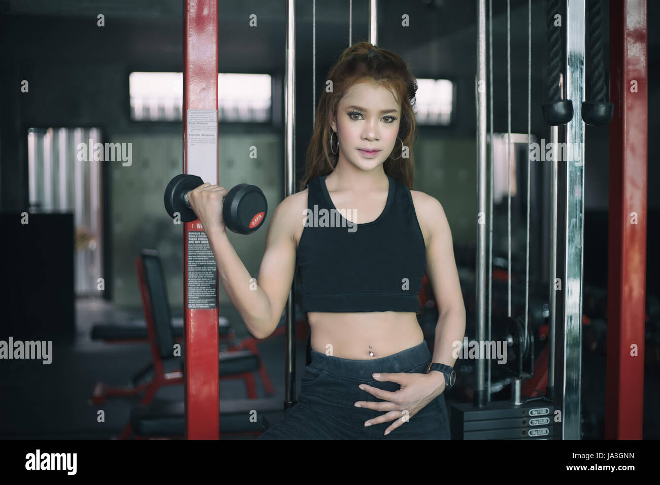 young fitness asian woman exercise with machine Cable Crossover and ...