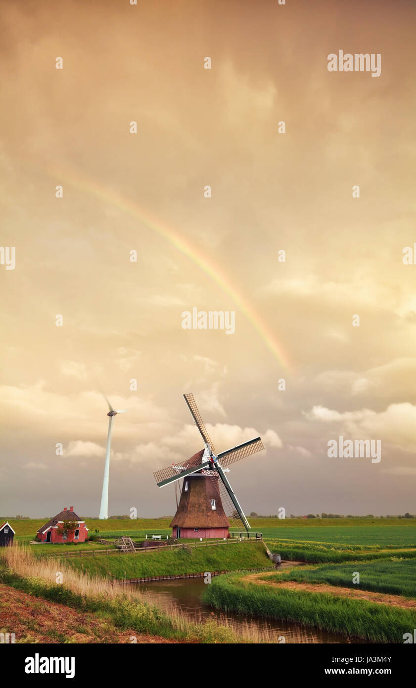 rainbow over Dutch windmill at sunset, Holland Stock Photo - Alamy