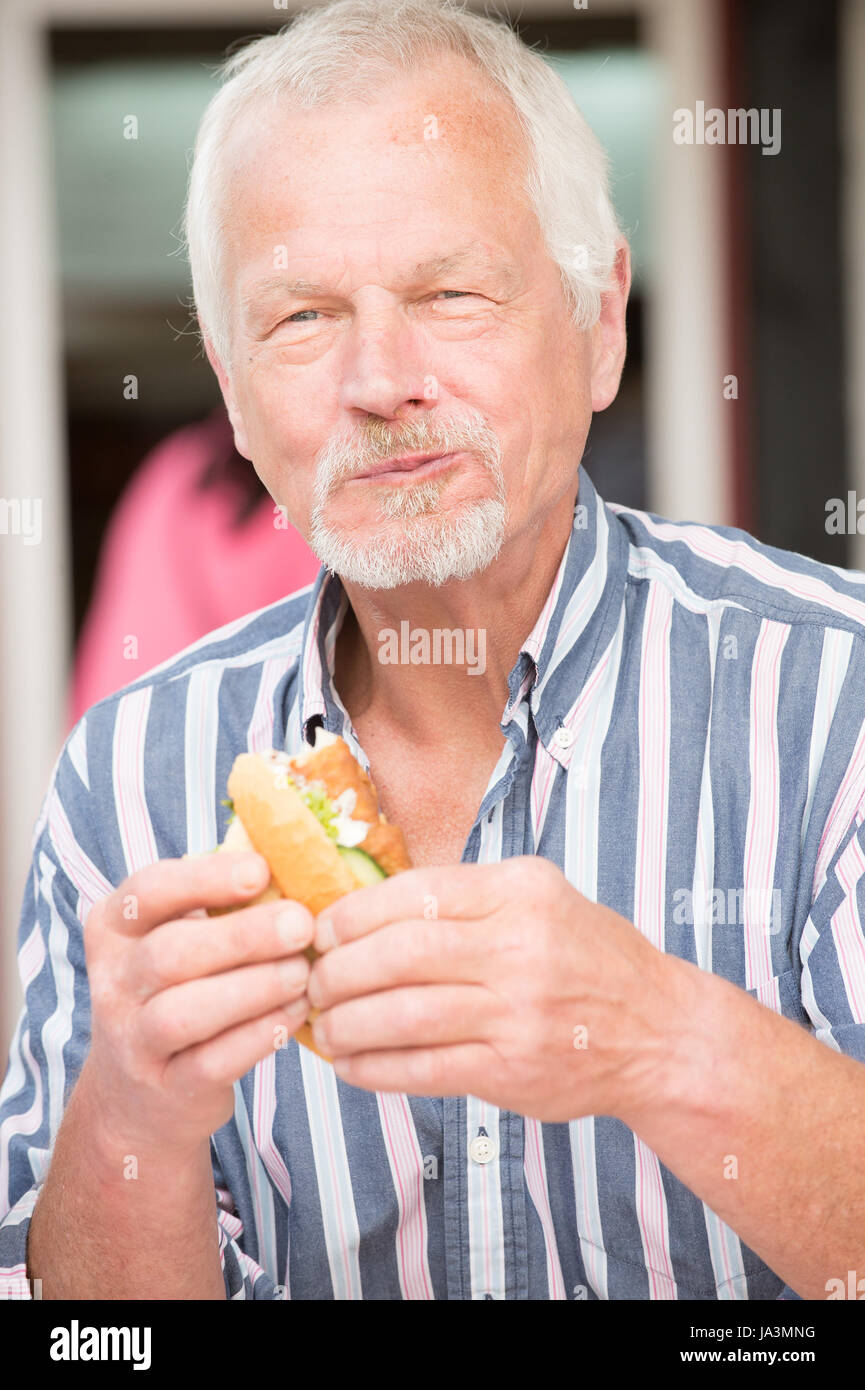 man eating fish sandwich Stock Photo - Alamy