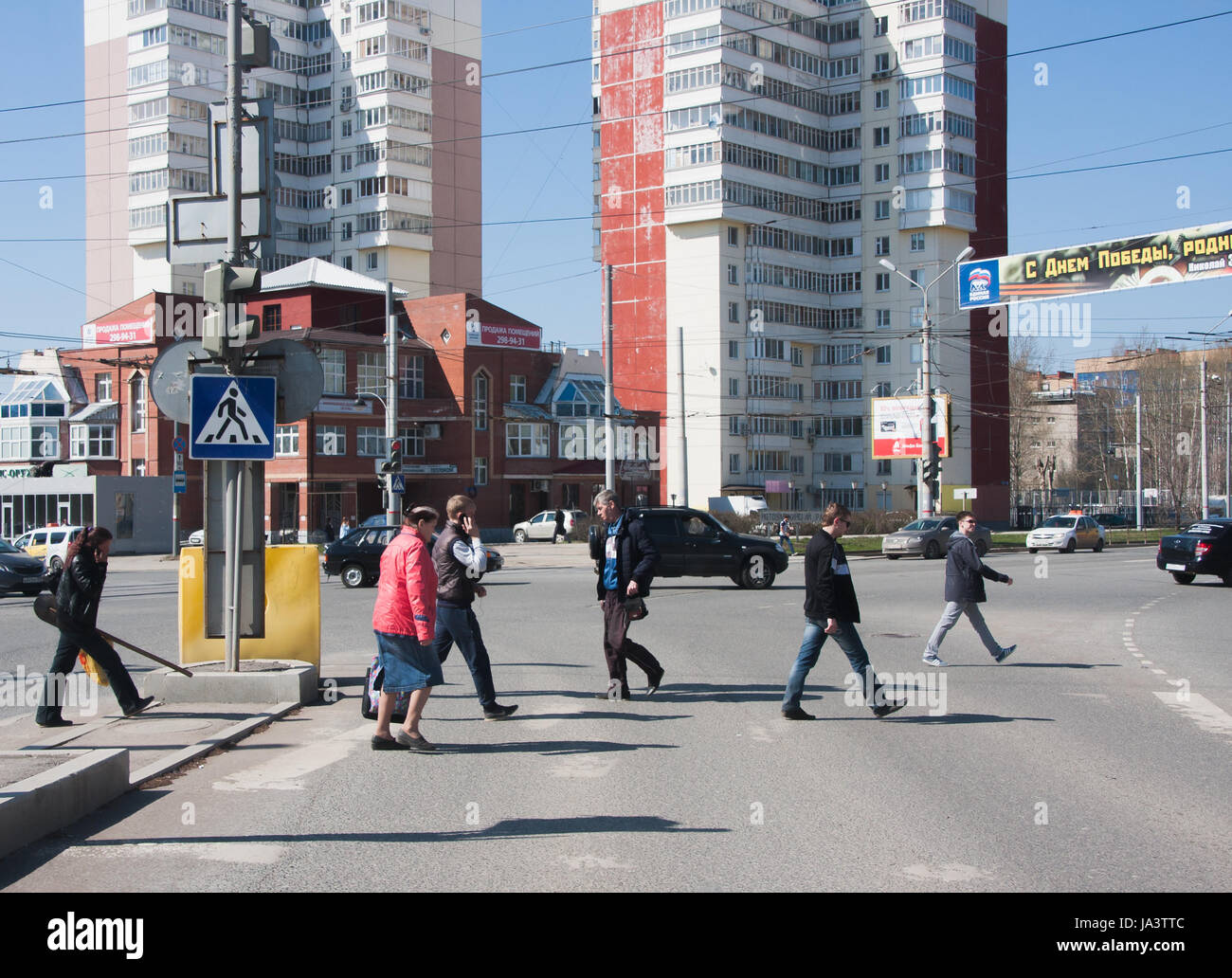Perm, Russia - April 30.2016: Pedestrians pass road to a green signal ...