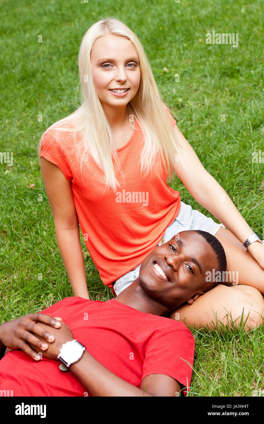young enamored multicultural couple in a meadow Stock Photo - Alamy