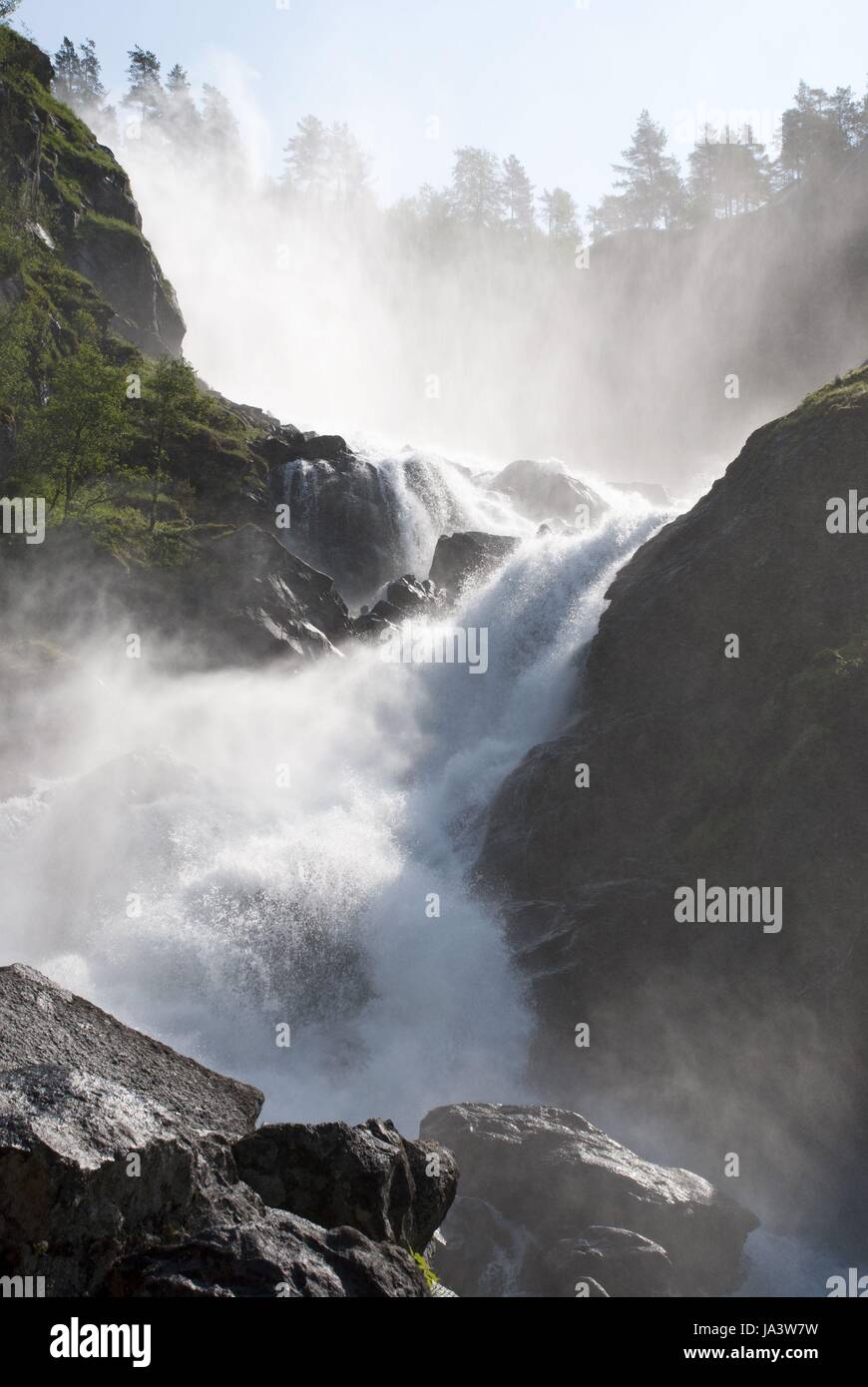 a huge and wild waterfall with trees surrounding it Stock Photo - Alamy