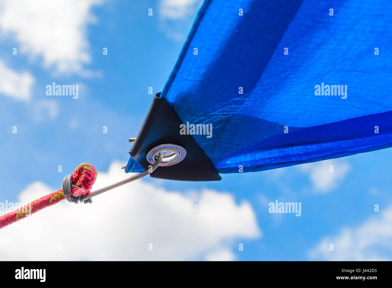 Awnings in sails shape over cloudy sky background. Detail of securing ...