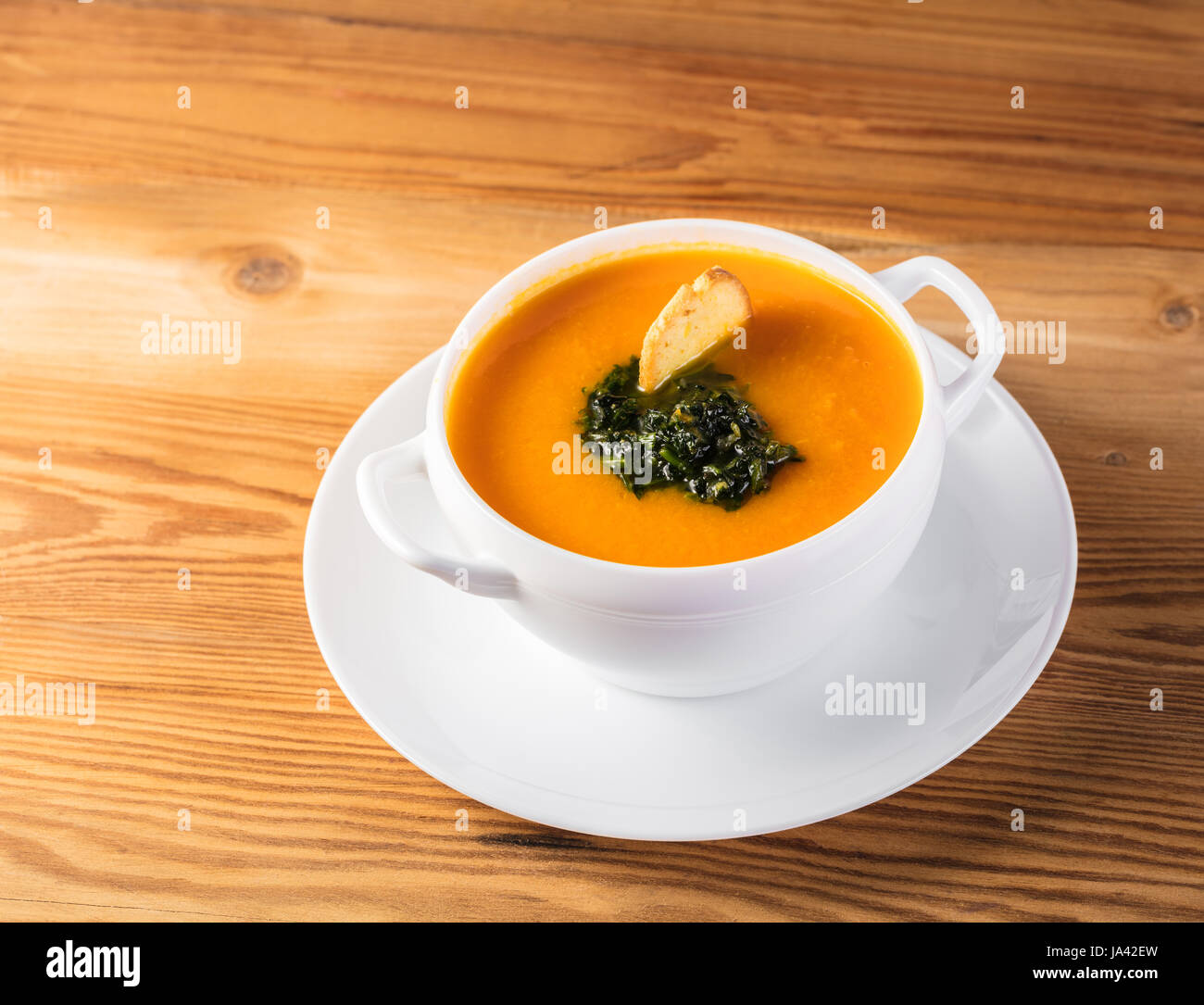 Carrot cream soup puree on a wooden background Stock Photo - Alamy
