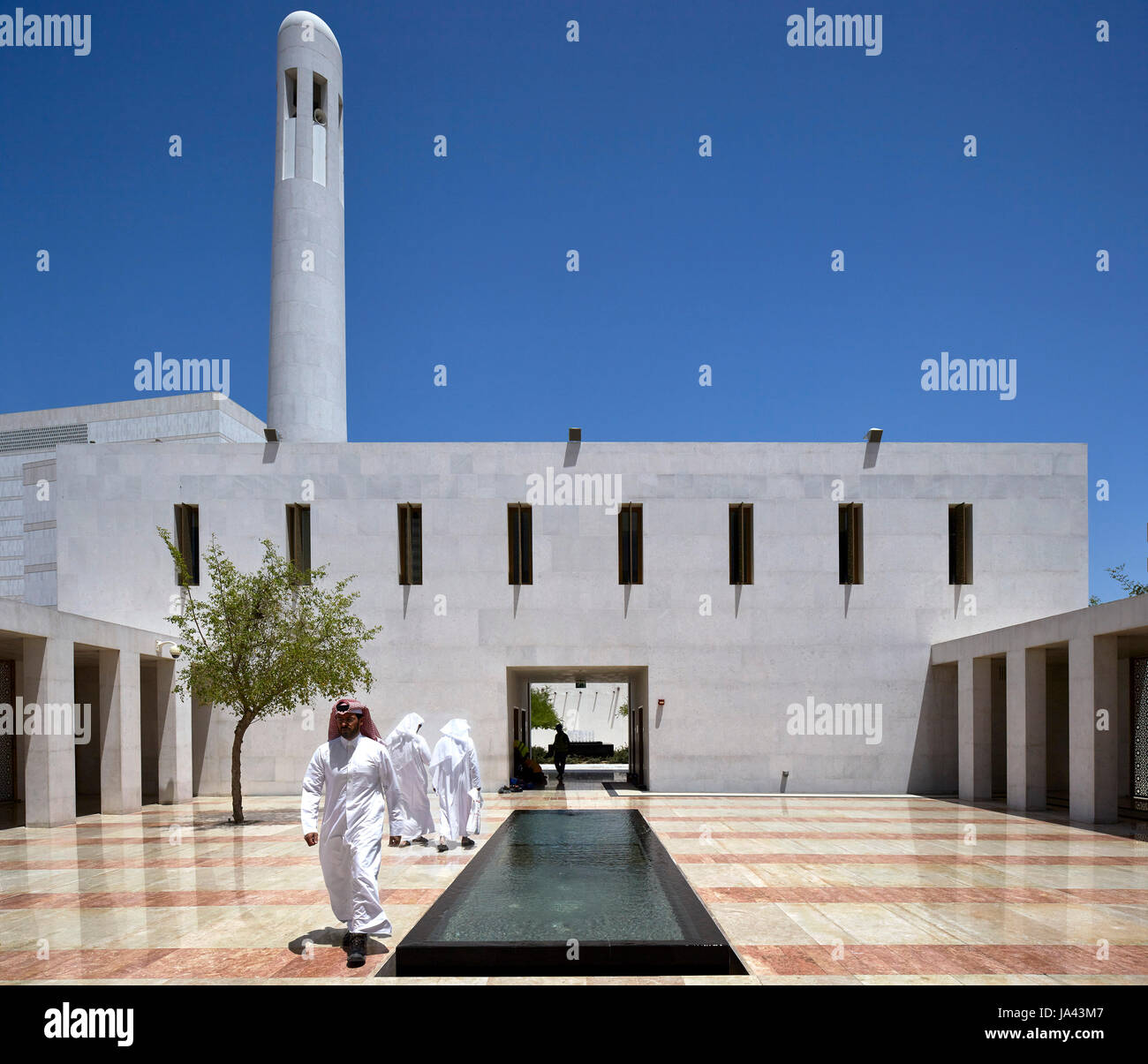 Mosque courtyard midday prayers with minaret. Jumaa Mosque, Doha ...