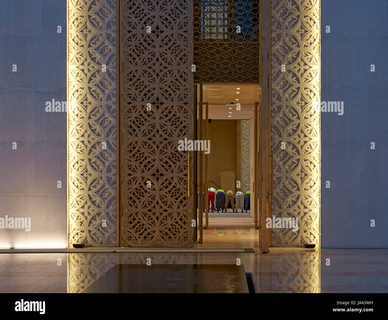 View into mosque through gold doors during prayers. Jumaa Mosque, Doha ...