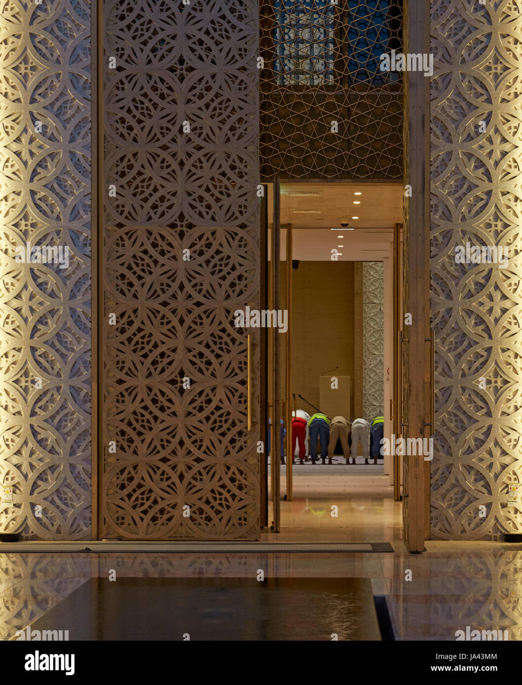 View into mosque through gold doors during prayers. Jumaa Mosque, Doha ...