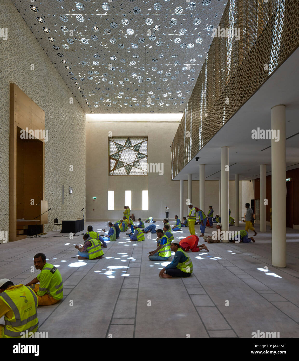 Interior of mosque during prayers with dappled light. Jumaa Mosque ...