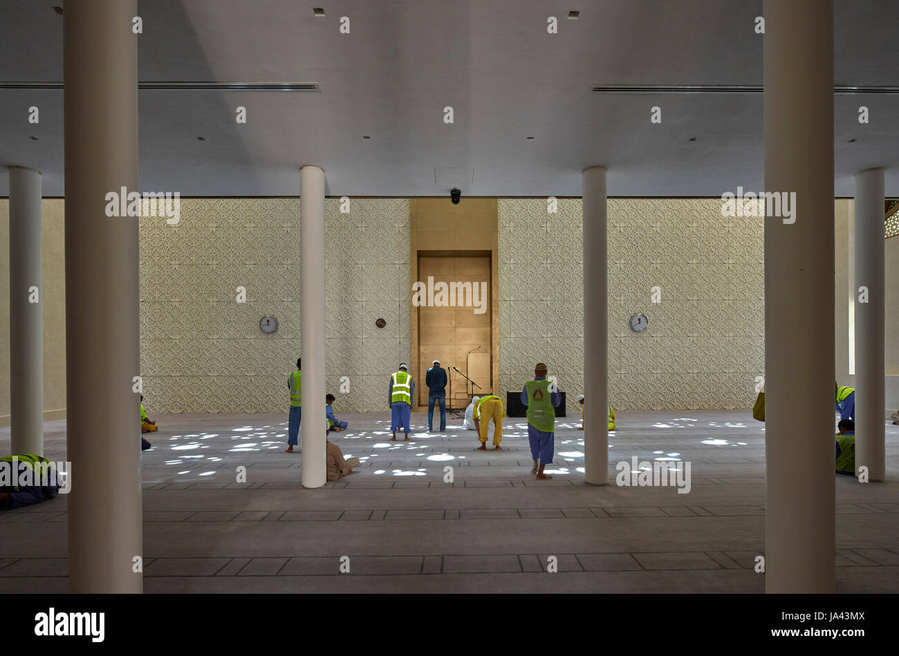 Interior of mosque during prayers with dappled light. Jumaa Mosque ...