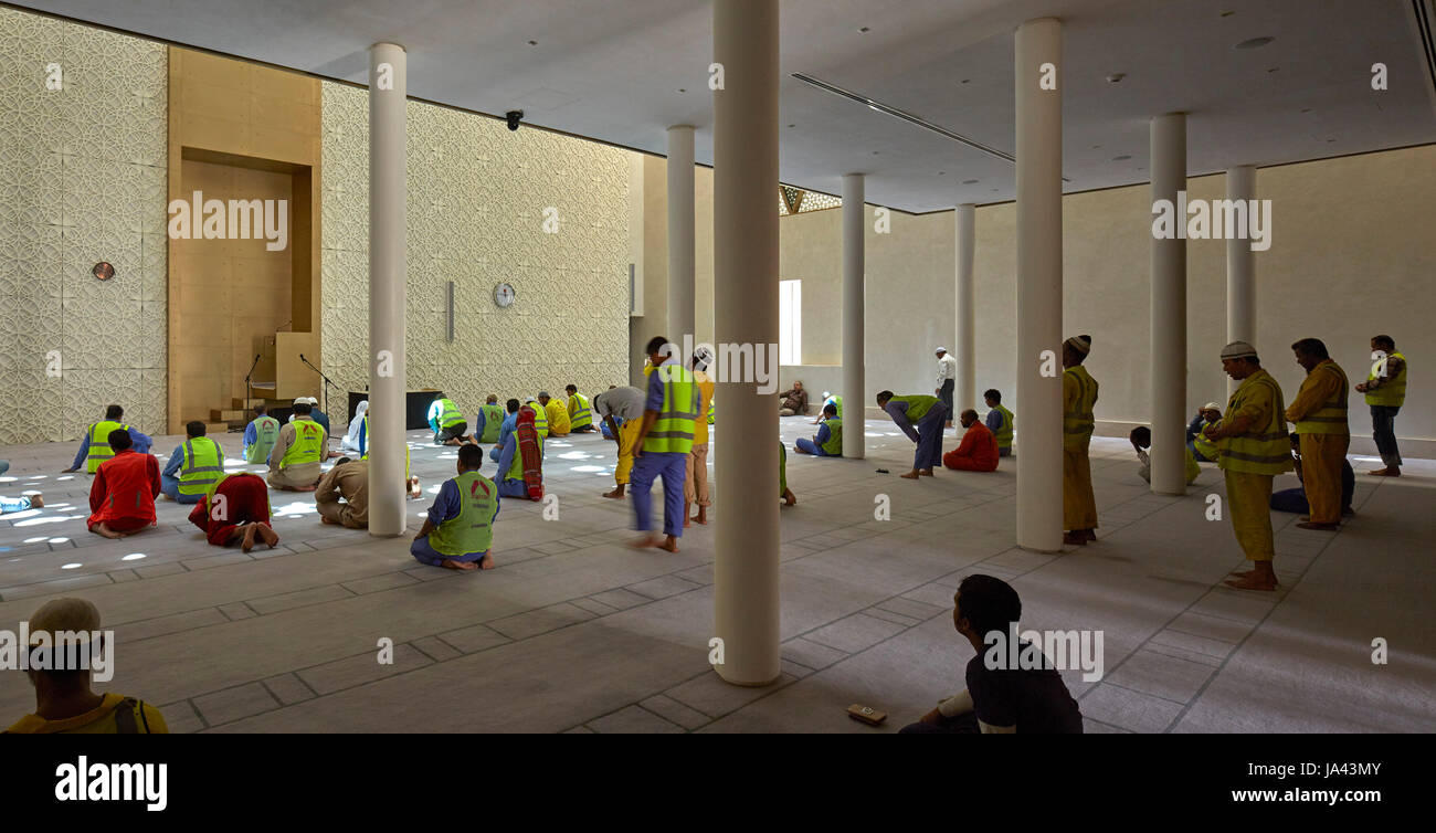 Interior of mosque during prayers with dappled light. Jumaa Mosque ...