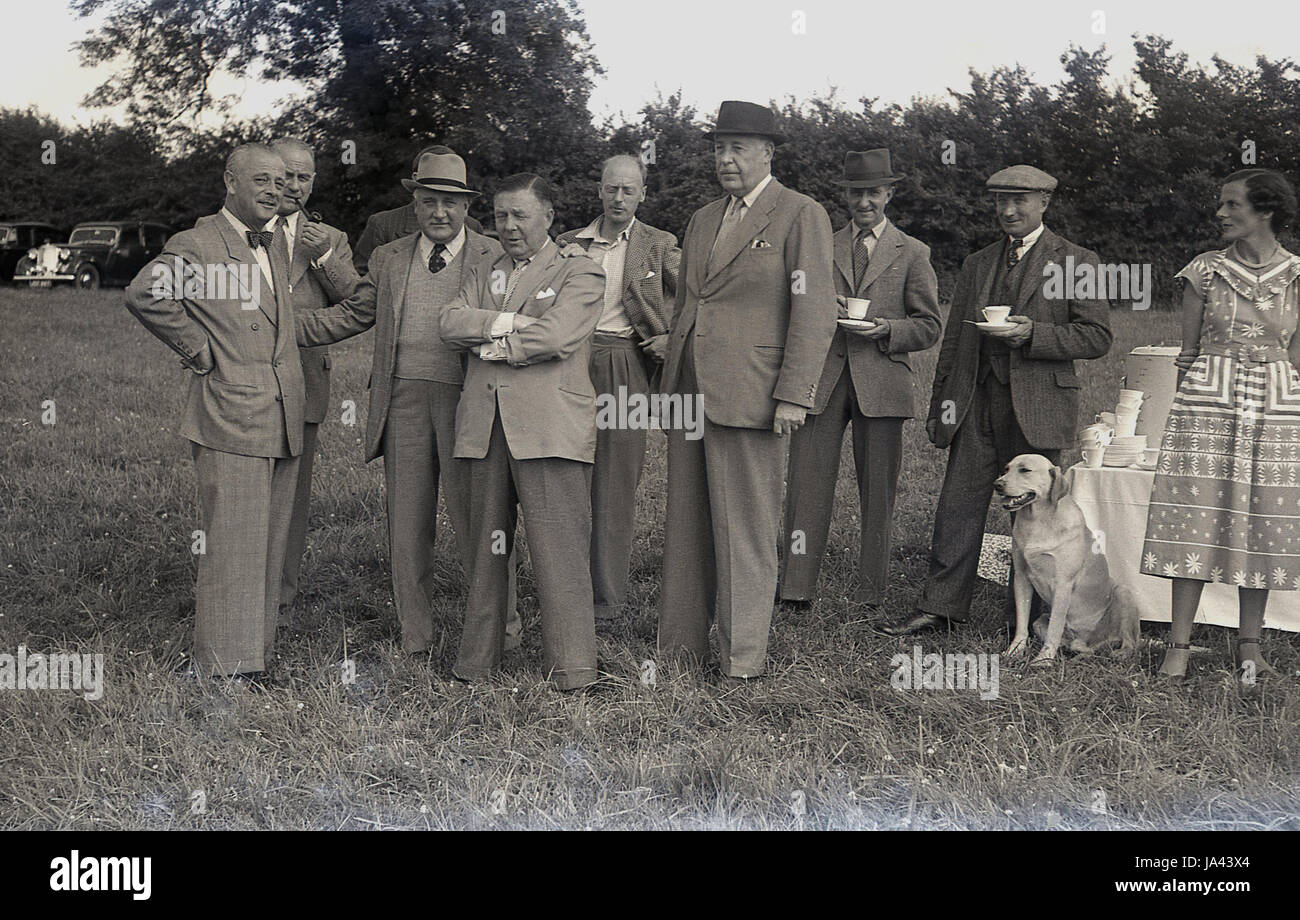 1950s, historical. group of well dressed gentlemen stand together ...