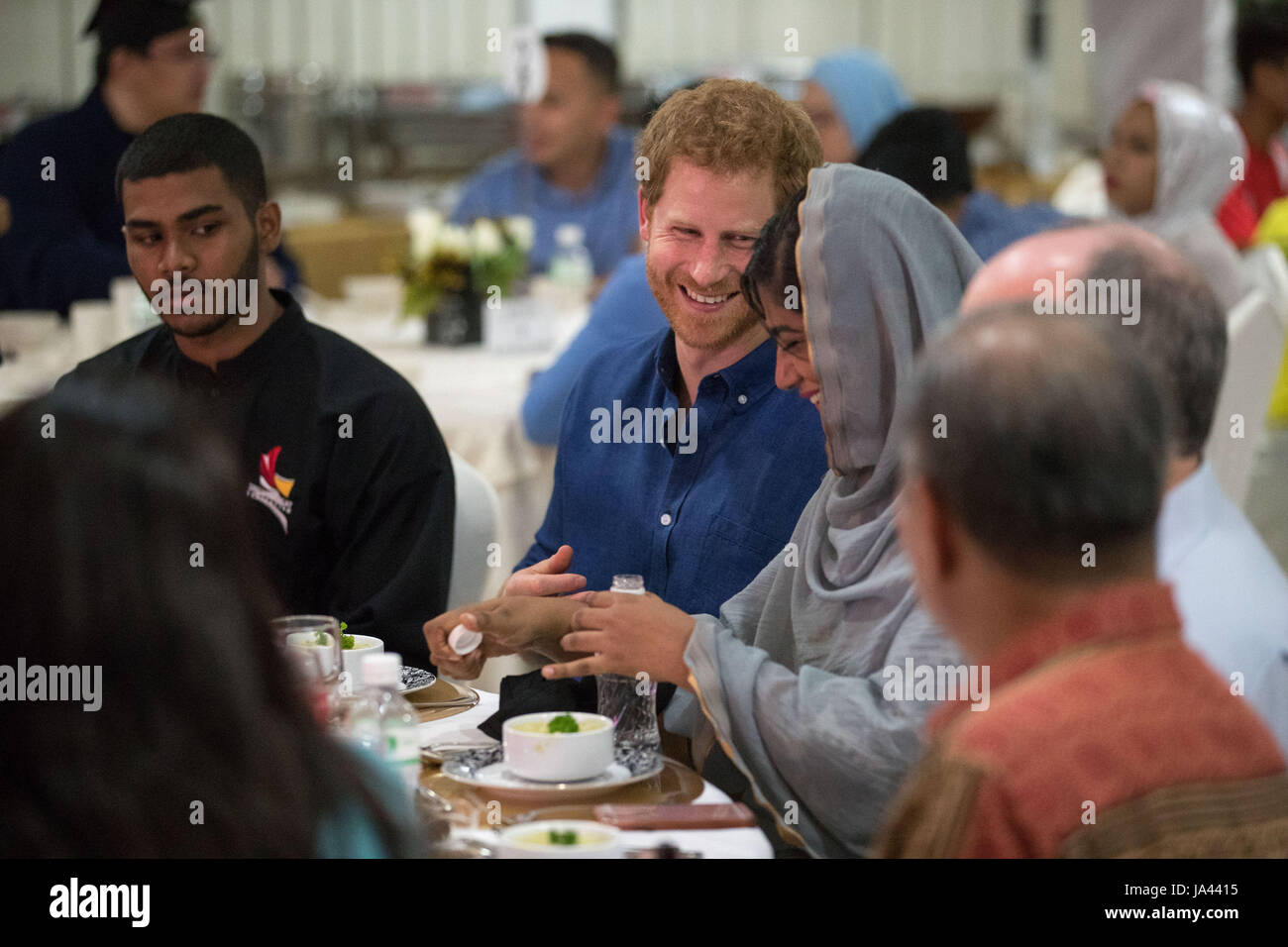 Prince Harry sits down for iftar, breaking of the fast, by eating ...