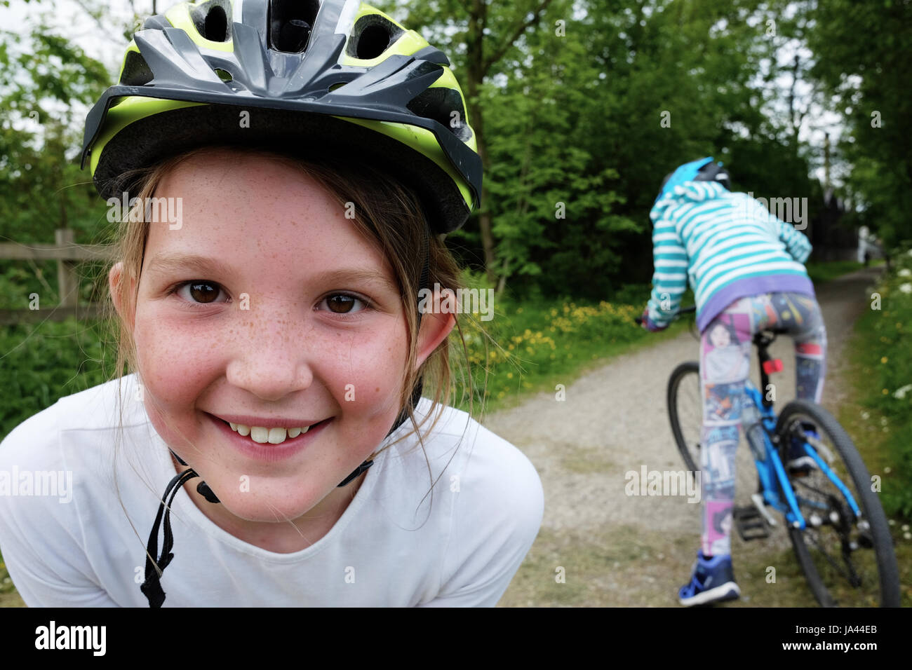 Two girls cycling on the Tissington and High Peak trail in the Peak ...