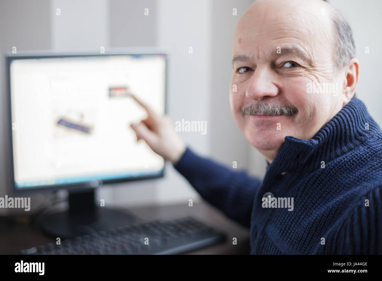 Man looking for information on the Internet. Retired develops computer ...