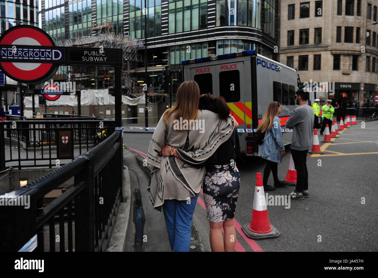 Two women hug after bringing flowers to add to tributes laid on the ...
