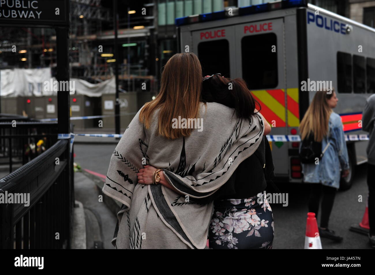 Two women hug after bringing flowers to add to tributes laid on the ...