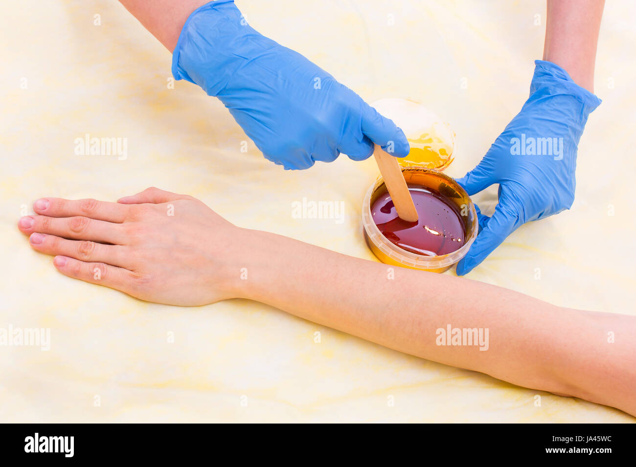 Depilation sugar processes woman passes in a beauty salon Stock Photo ...