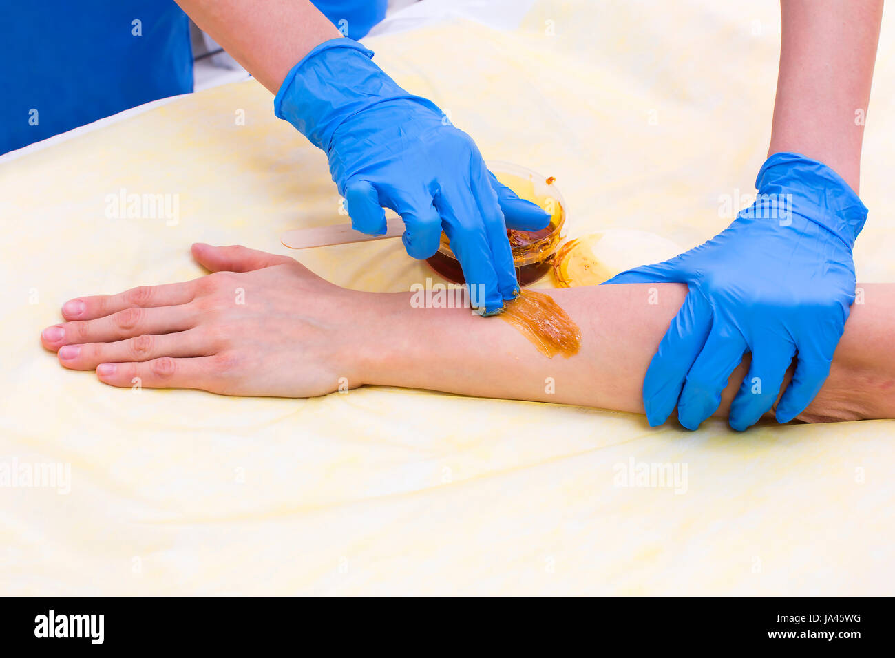 Depilation sugar processes woman passes in a beauty salon Stock Photo ...