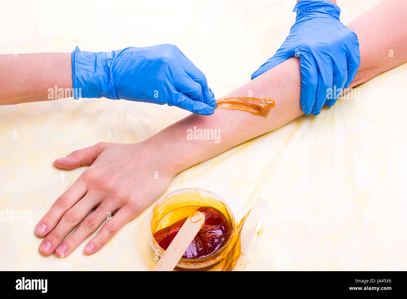 Depilation sugar processes woman passes in a beauty salon Stock Photo ...