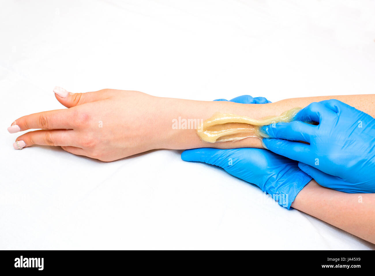 Depilation sugar processes woman passes in a beauty salon Stock Photo ...