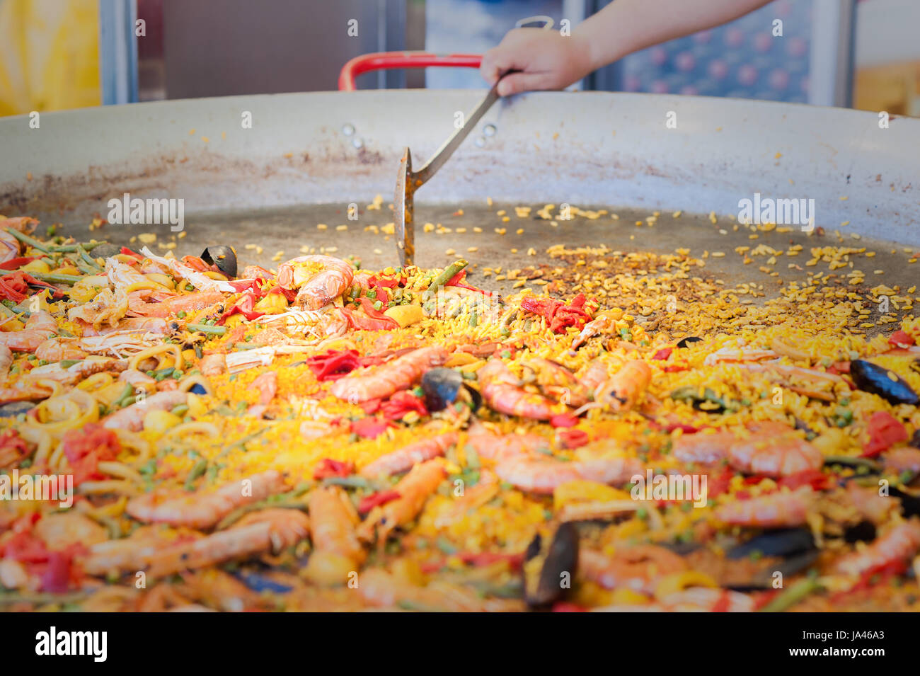 Seafood paella in a paella pan at a street food market Traditional ...