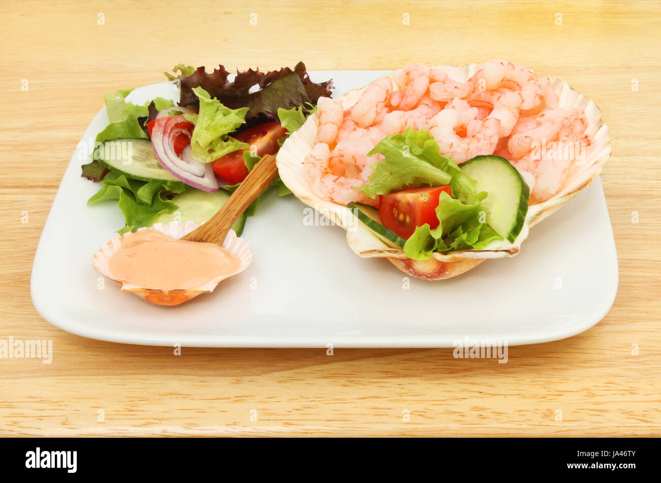 Prawn salad, prawns in a scallop shell with salad and seafood sauce on ...