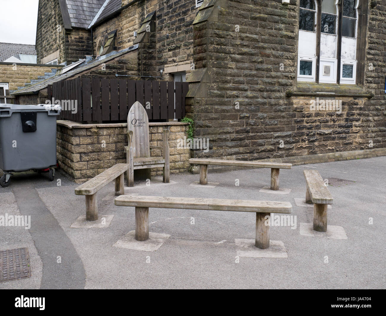 Wooden bench seating outside school Stock Photo - Alamy