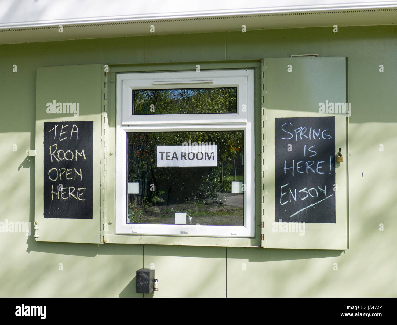 Tea room window in green wall Stock Photo - Alamy