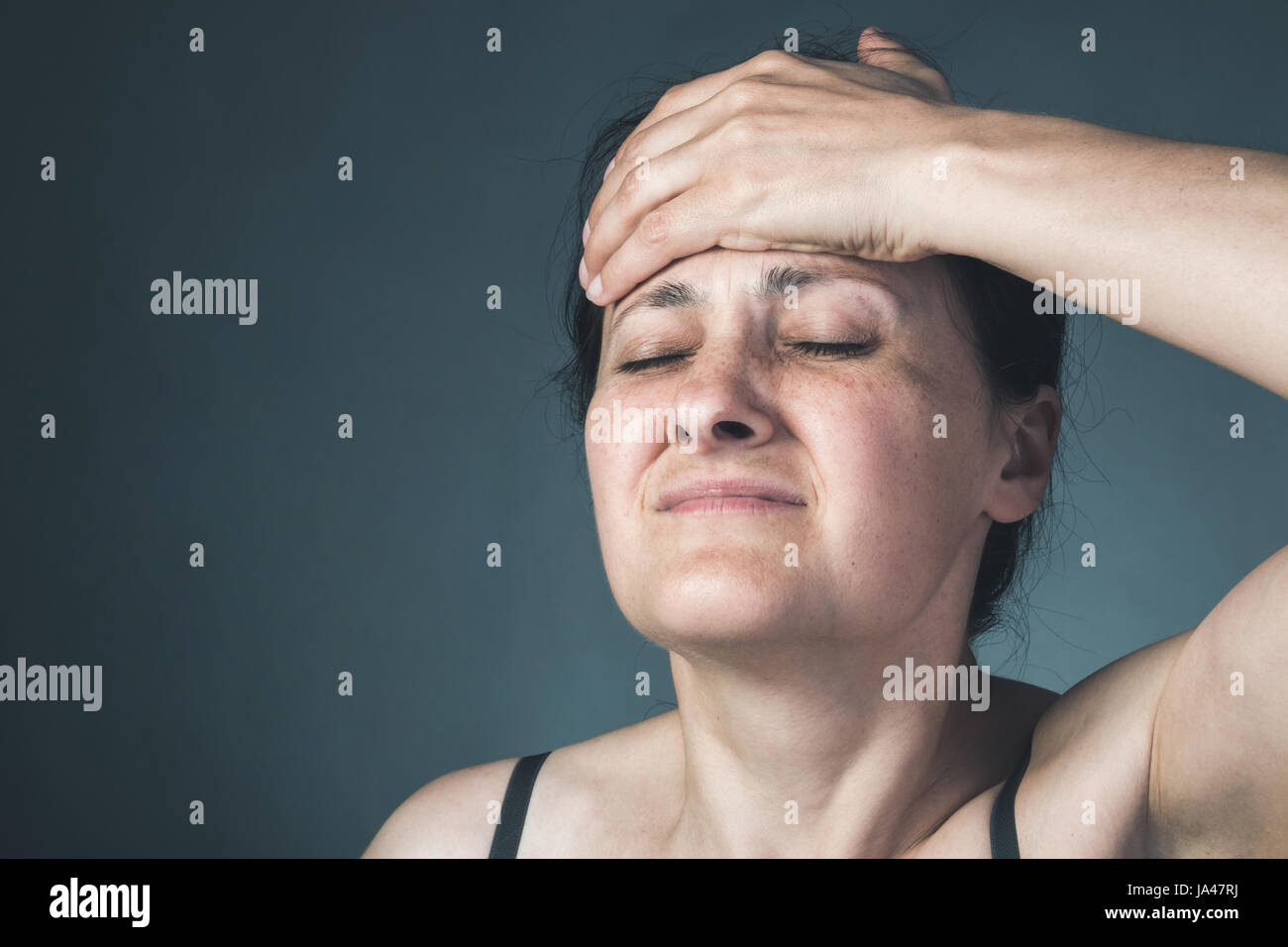 Sad woman having a headache Stock Photo - Alamy