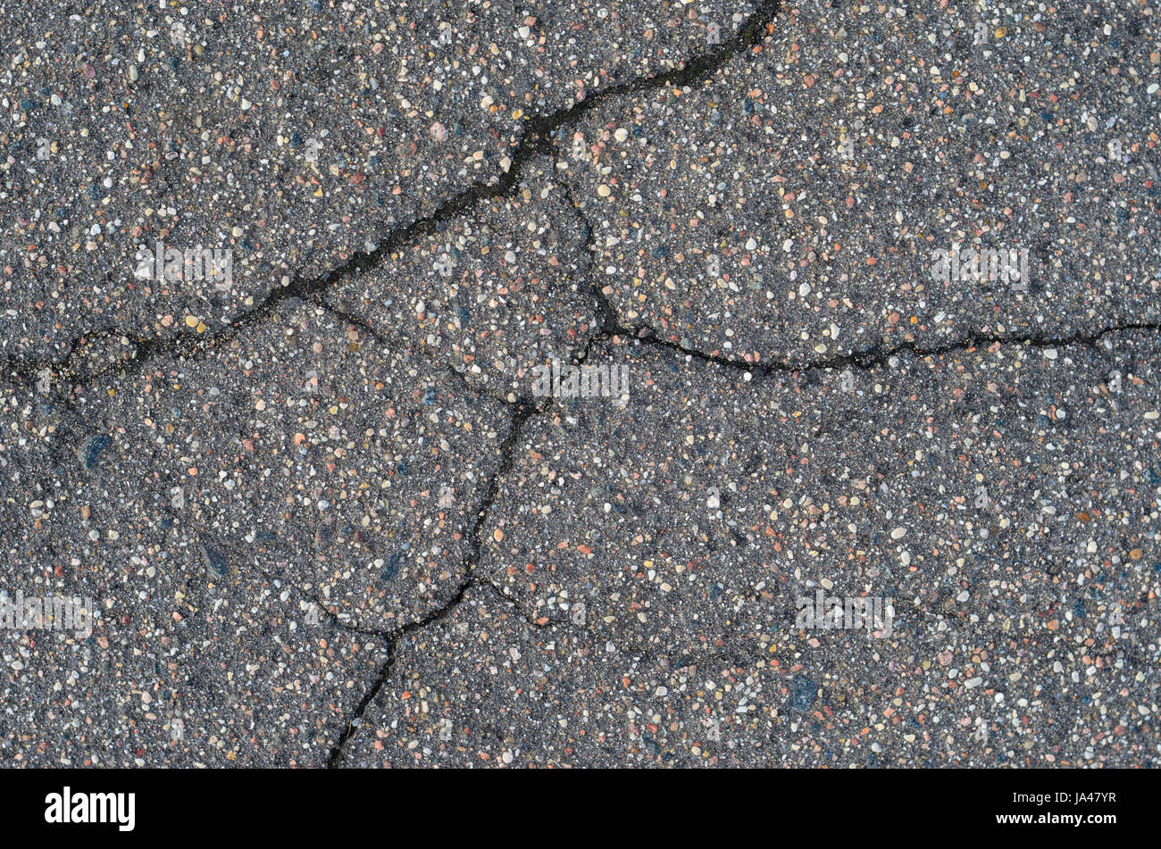 Asphalt texture with cracks. The texture of asphalt strongly cracked ...