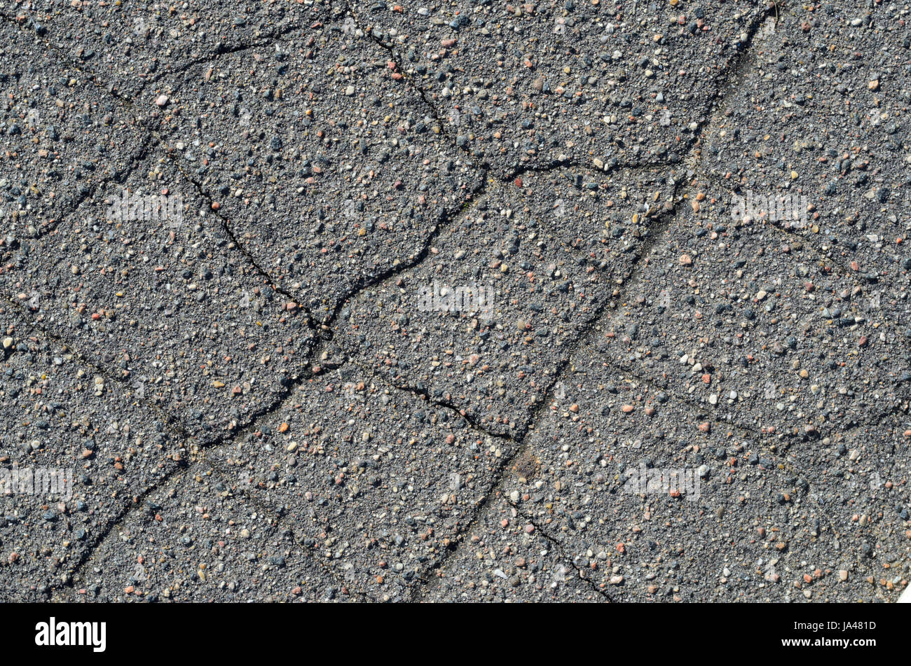 Asphalt texture with cracks. The texture of asphalt strongly cracked ...